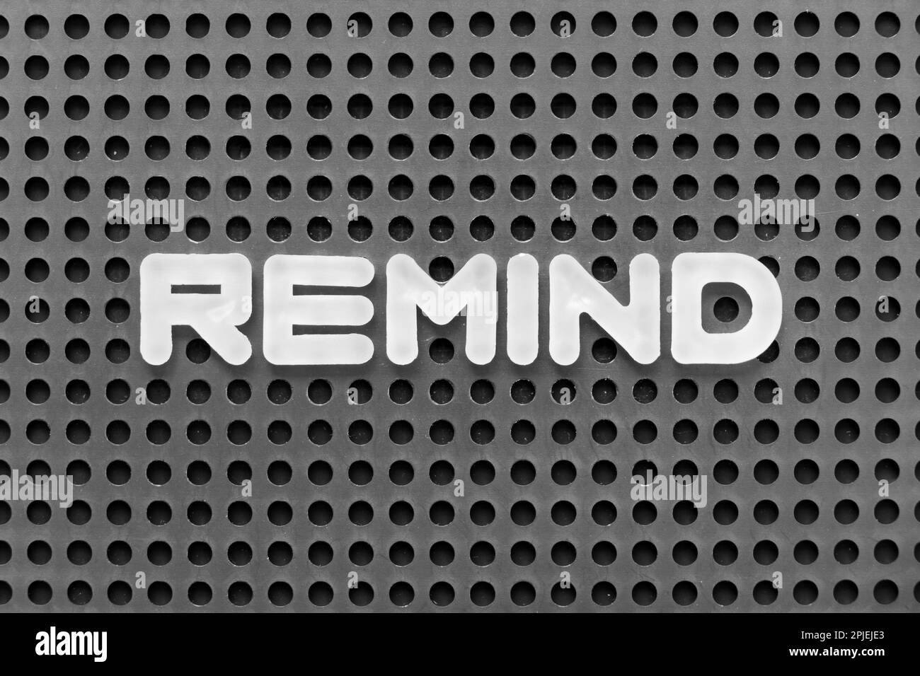 White alphabet letter in word remind on black pegboard background Stock ...