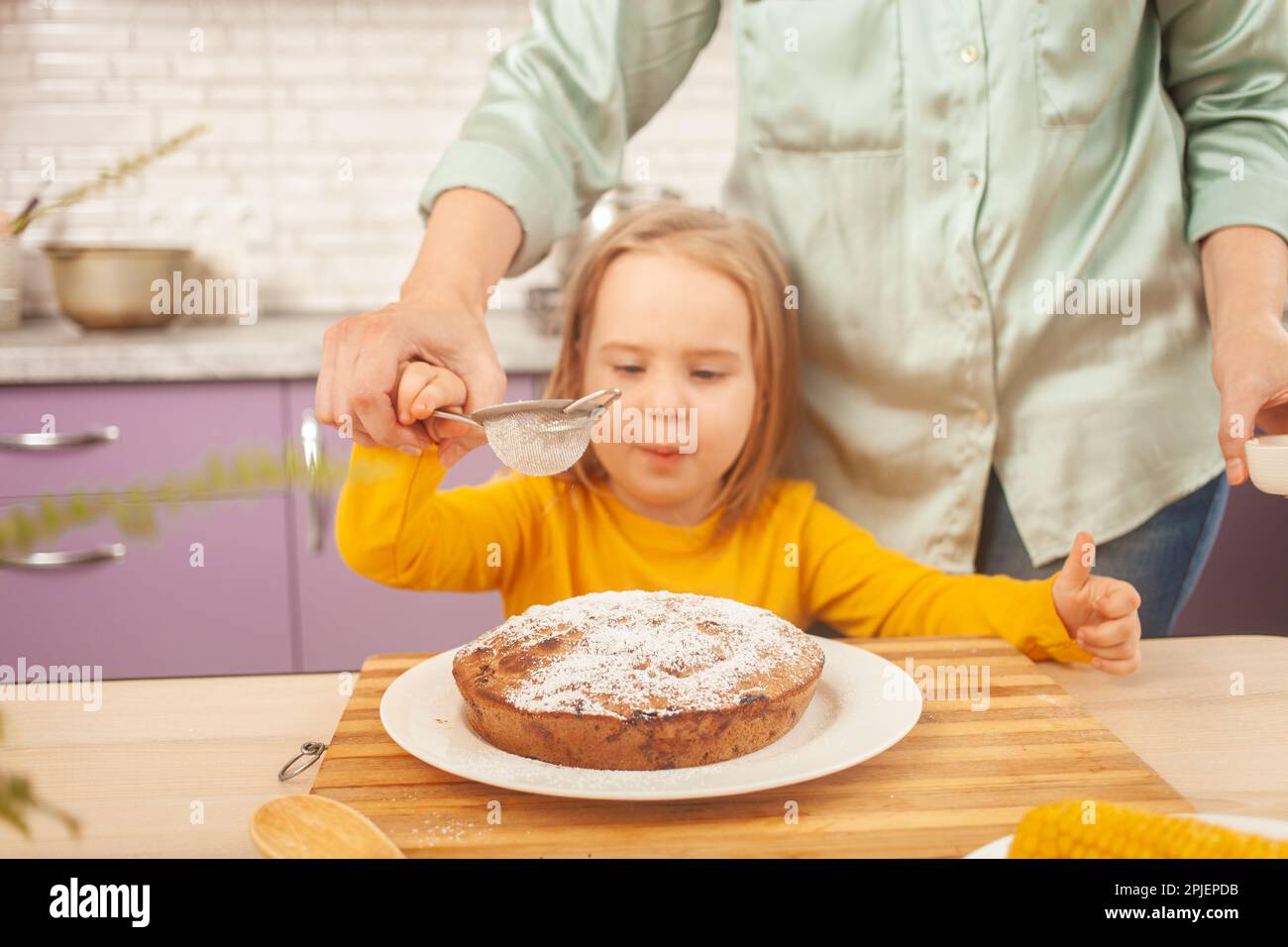 Portrait of little girl of three years old, kitchen, pie, dabbling ...