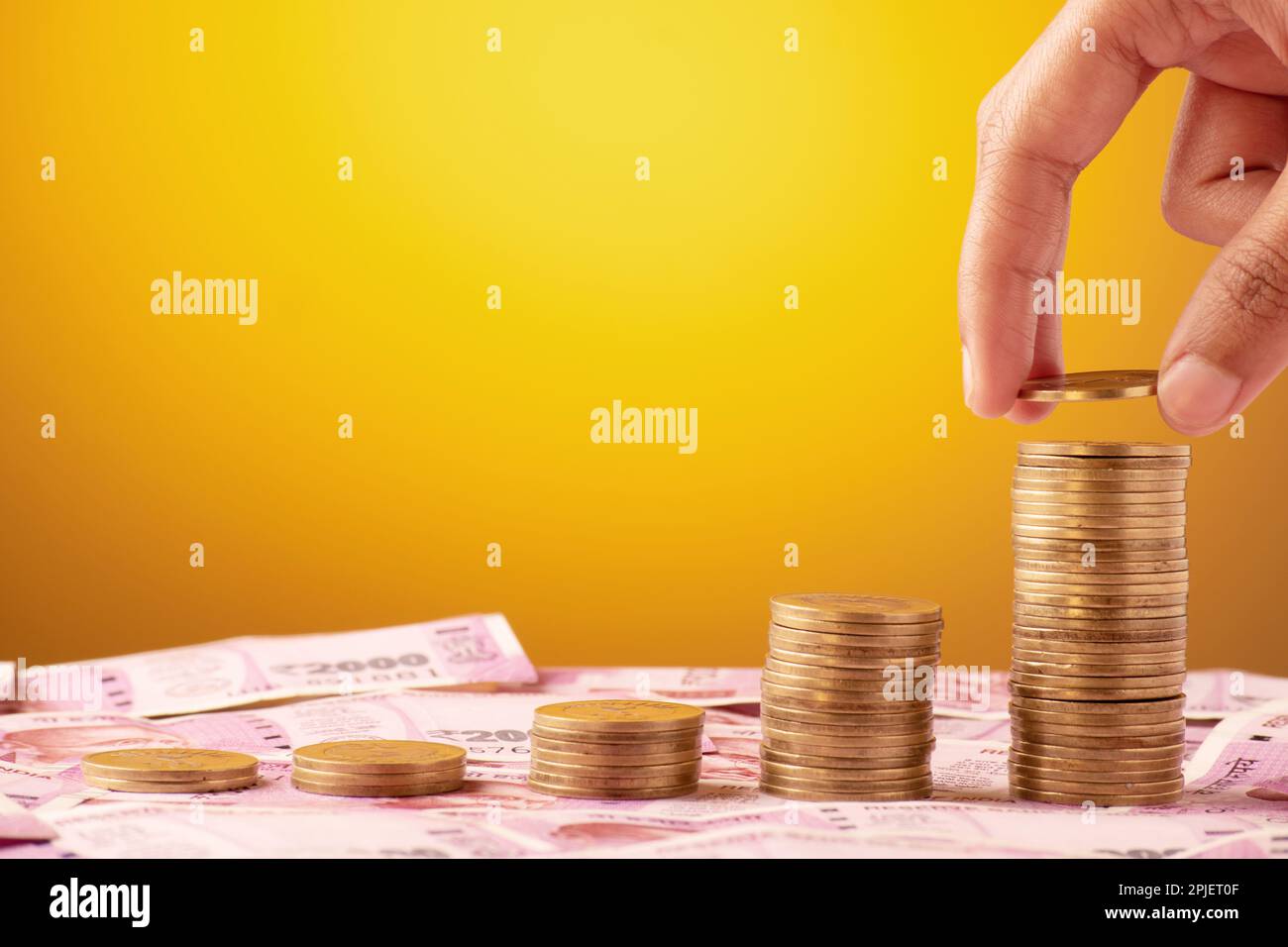 Hand putting money in stock, money management concept Stock Photo - Alamy