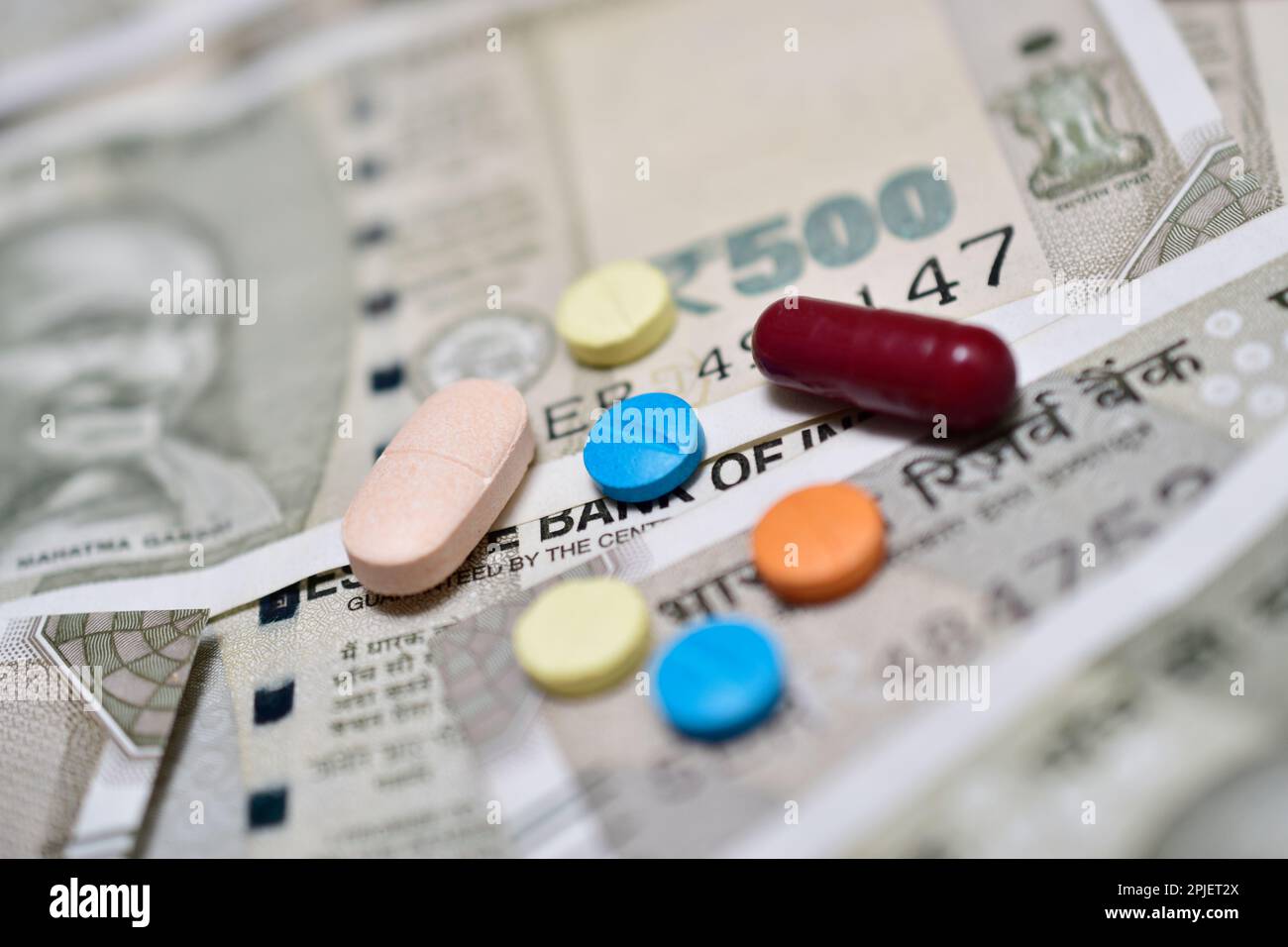 Medicine pills and tablet with indian currency note Stock Photo - Alamy
