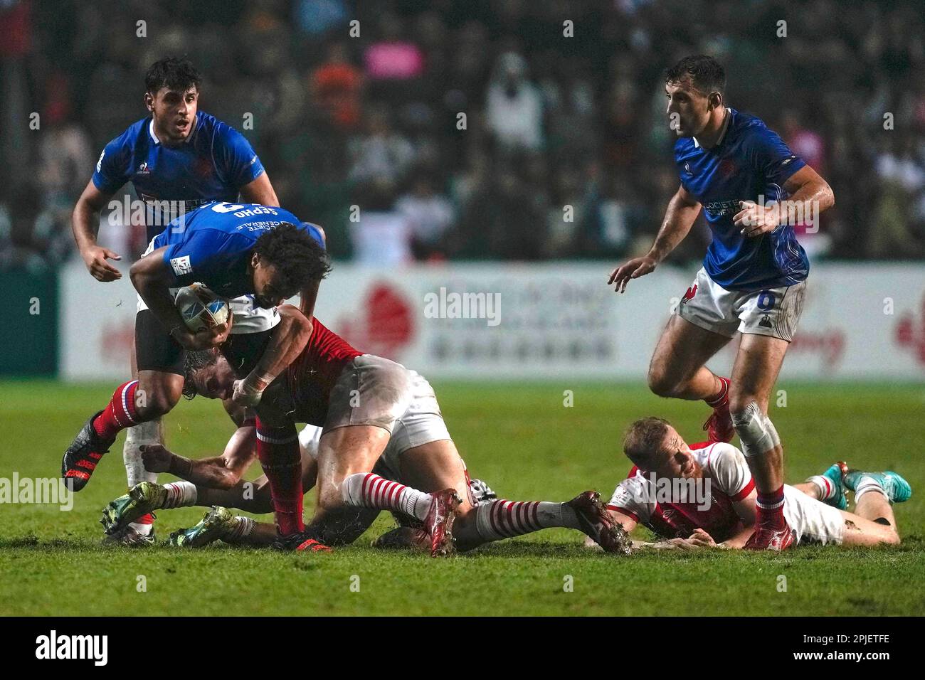 France's Jordan Sepho, left, holds the ball as he is tackled by Britain ...