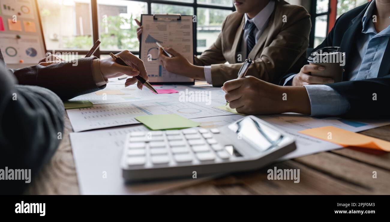 Diverse businesspeople cooperate work together discussing company financial statistics ...