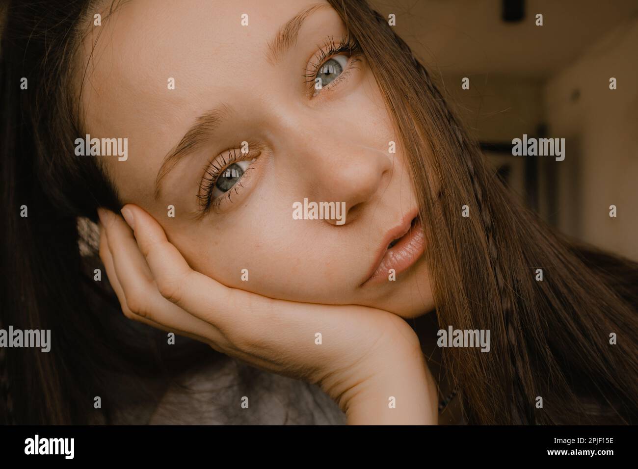 A face of a young woman with beautiful eyes looking in camera. A girl ...