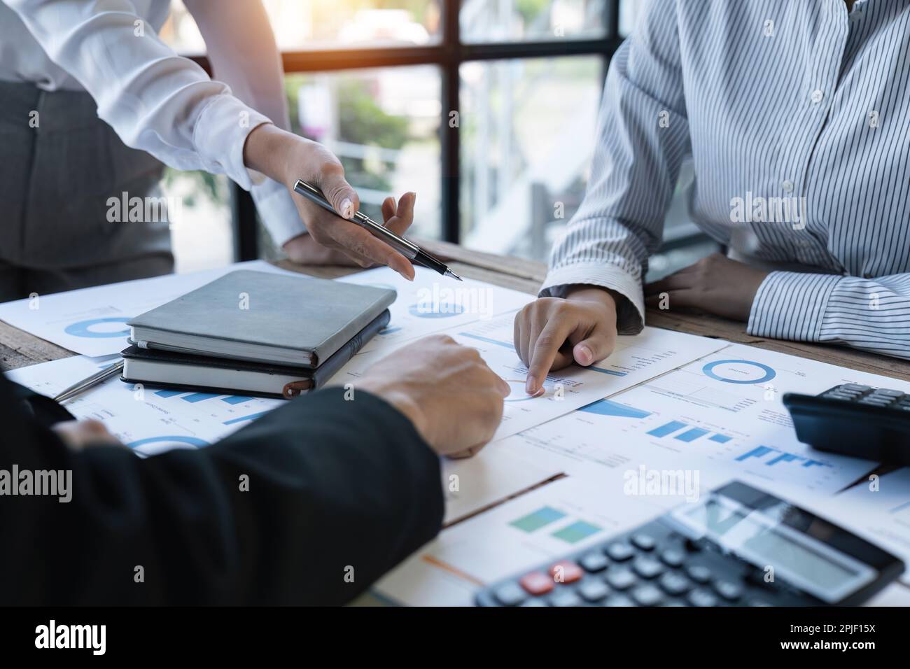 Diverse businesspeople cooperate work together discussing company financial statistics ...