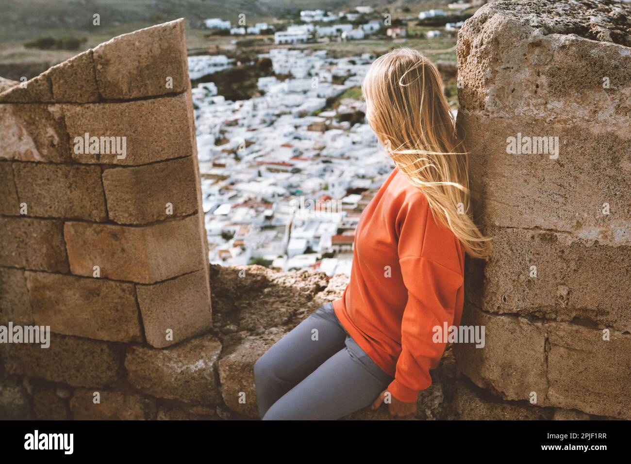 Tourist woman sightseeing Lindos town traveling in Greece, Rhodes ...