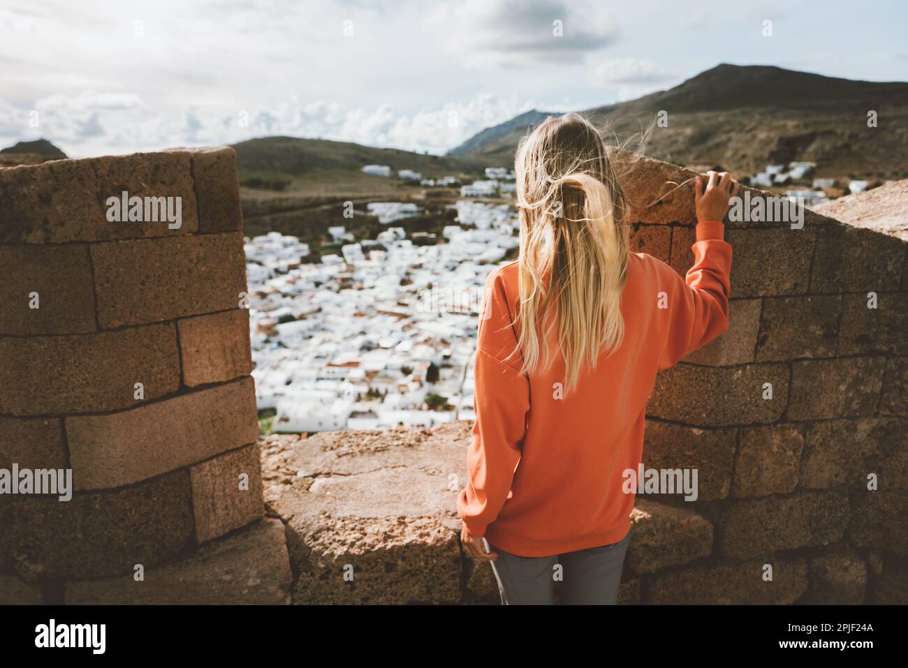 Woman traveling in Greece, Rhodes island sightseeing Lindos town aerial ...
