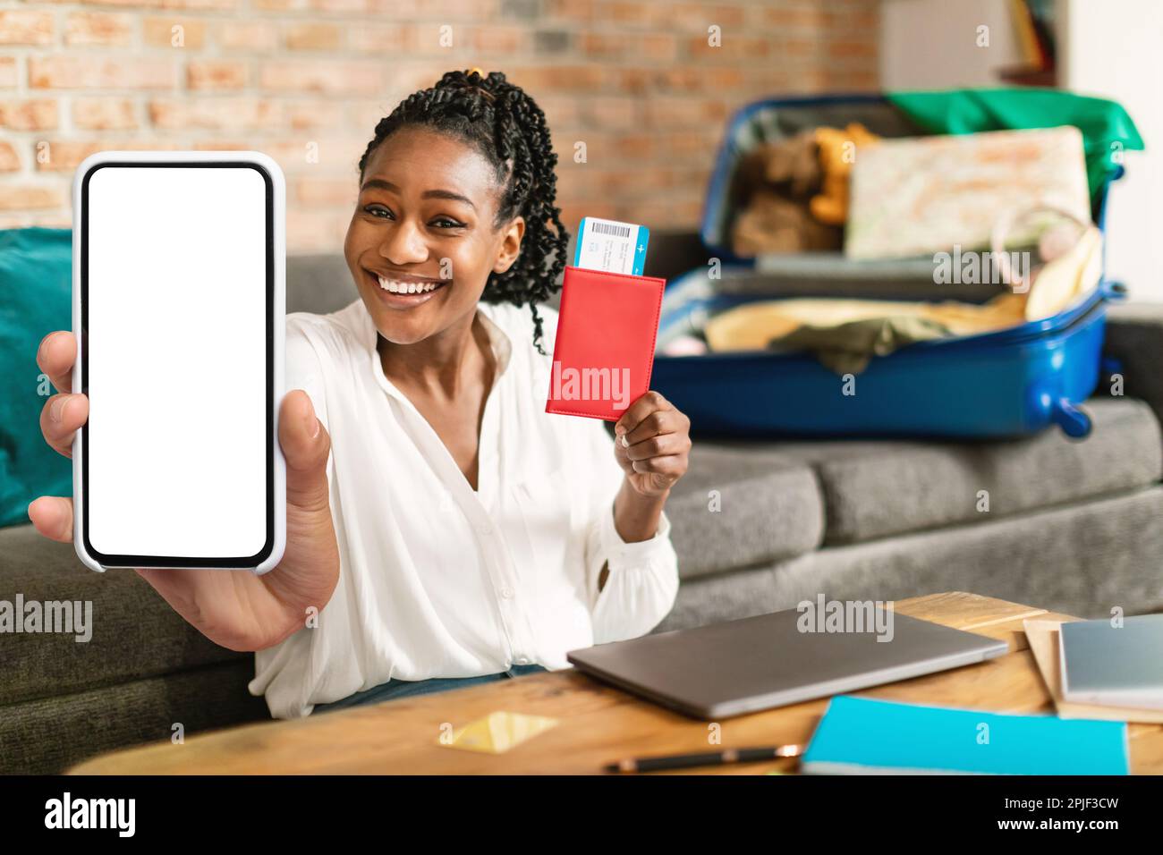 Online tour ot hotel booking app. Happy black woman holding passport ...