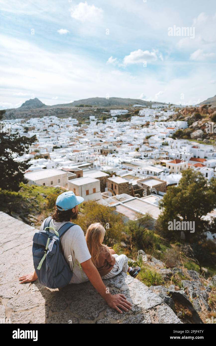 Greece family vacations man with child sightseeing Lindos city aerial ... Greece family vacations man with child sightseeing Lindos city aerial ...
