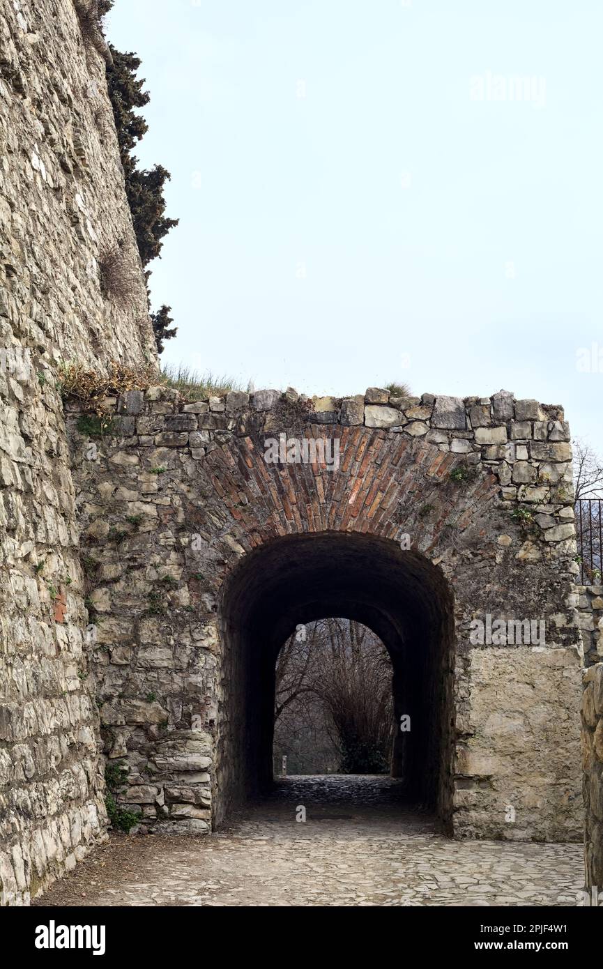 Entrance to a covered passage of a castle in a park on a cloudy day ...