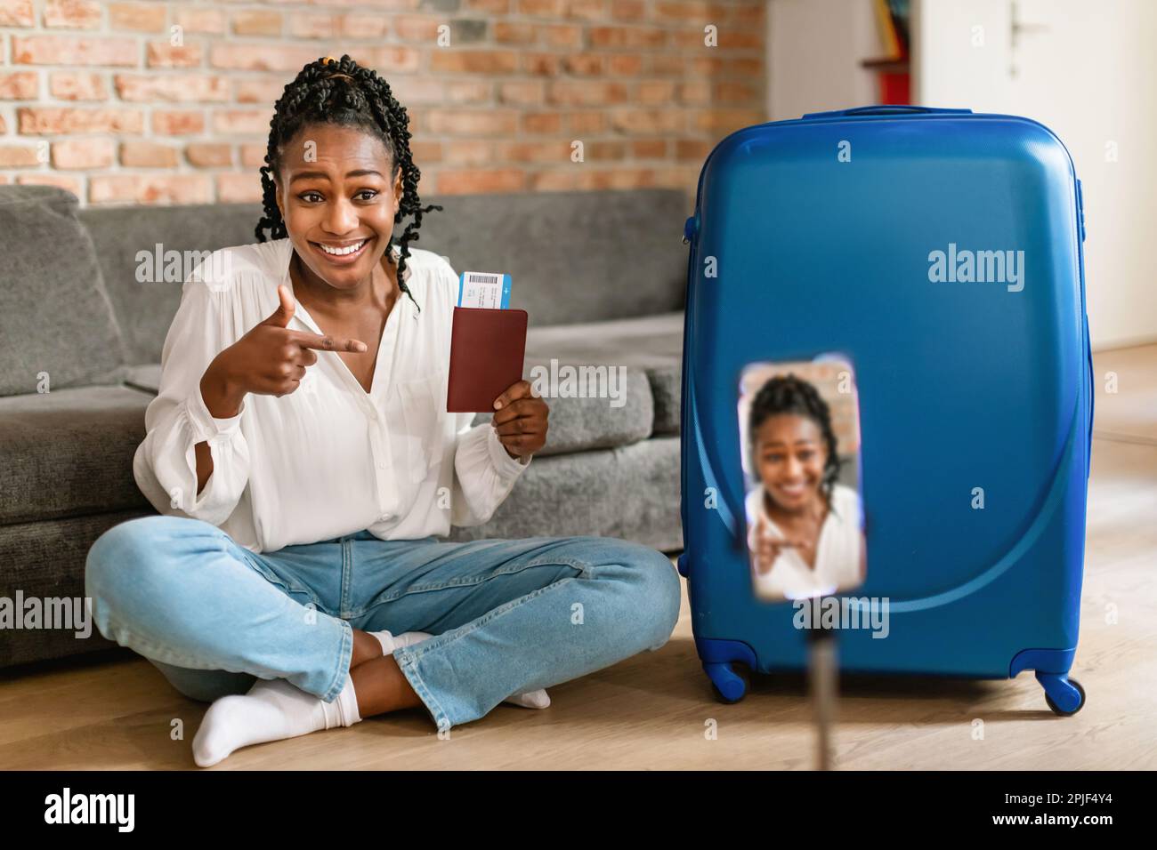 Happy black female travel blogger live streaming content for her vlog ...