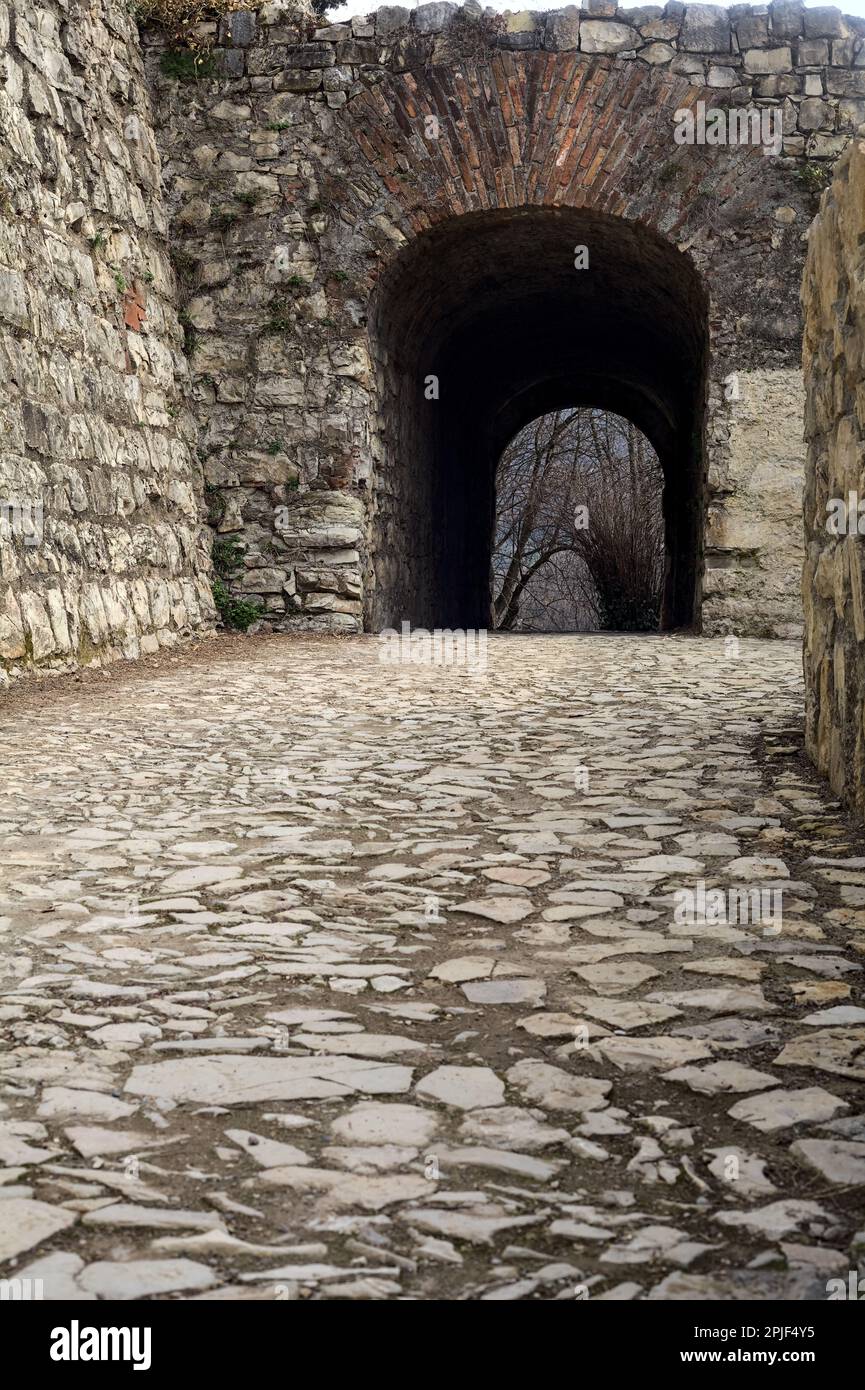 Entrance to a covered passage of a castle in a park on a cloudy day ...