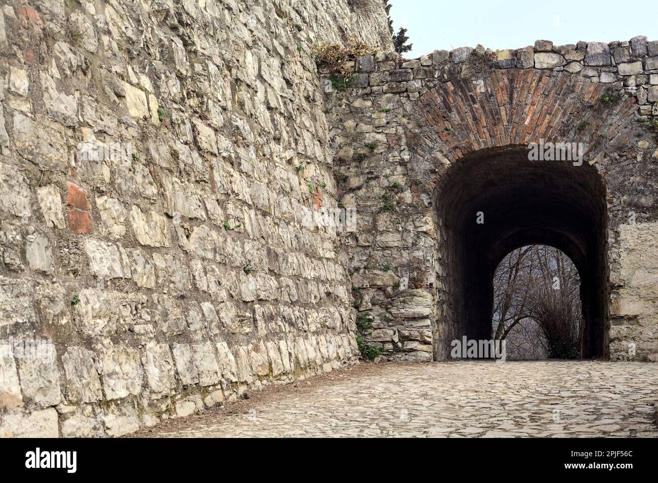 Entrance to a covered passage of a castle in a park on a cloudy day ...