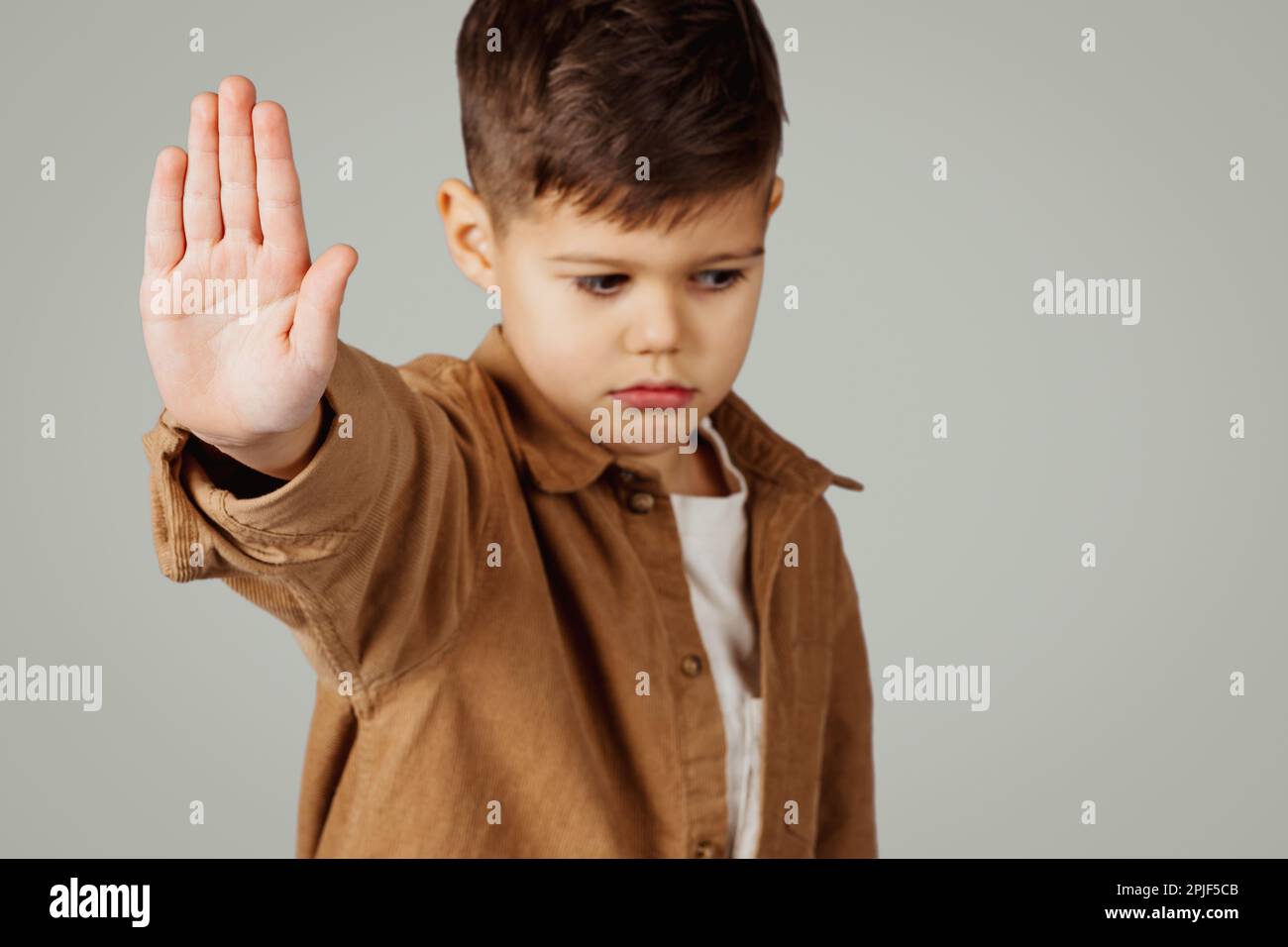 Sad caucasian 6 years old little boy show stop gesture with hand ...