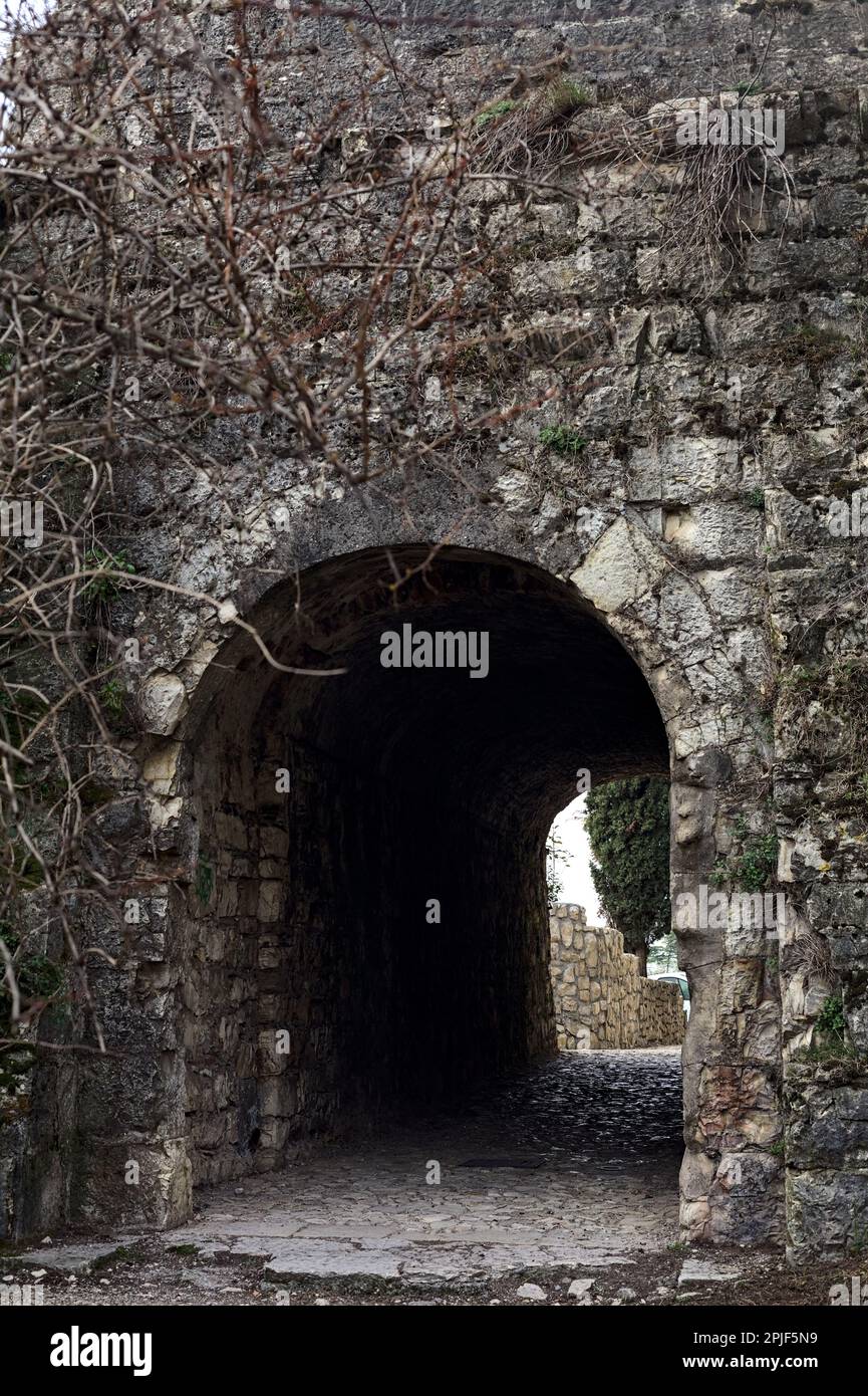 Entrance to a covered passage of a castle in a park on a cloudy day ...