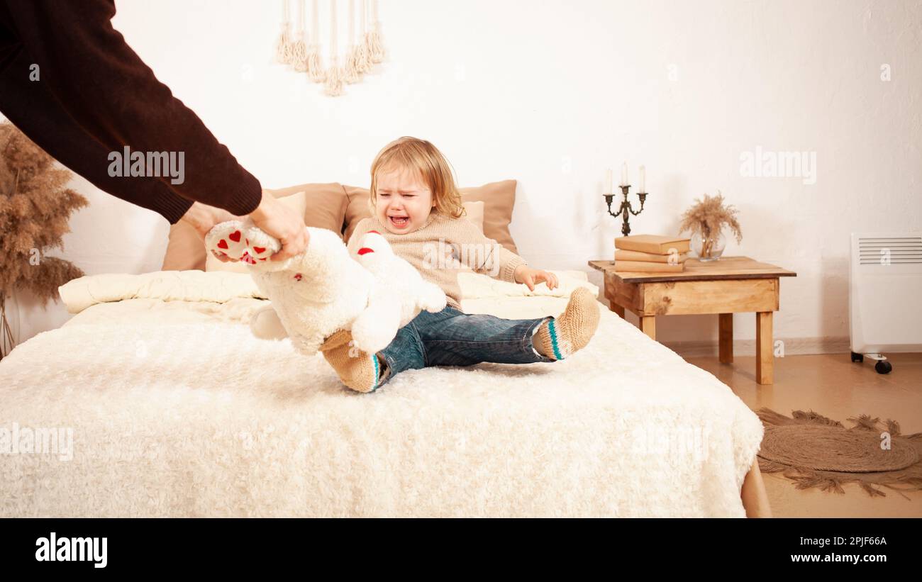 The child does not want to share toys, cries screaming hysterical. A ...