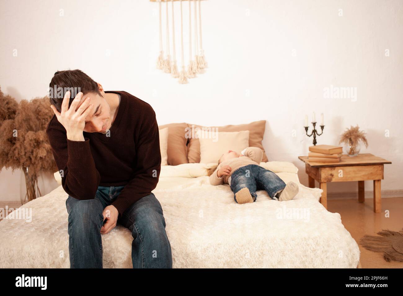 Dad can not cope with the child, a two-year-old girl lies on the bed ...