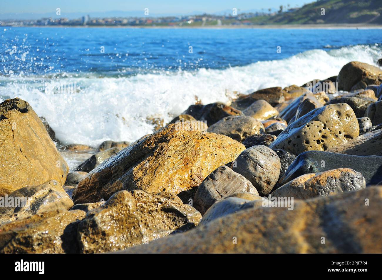 Wave-worn rocks piled along a rugged shore. High quality photo Stock ...