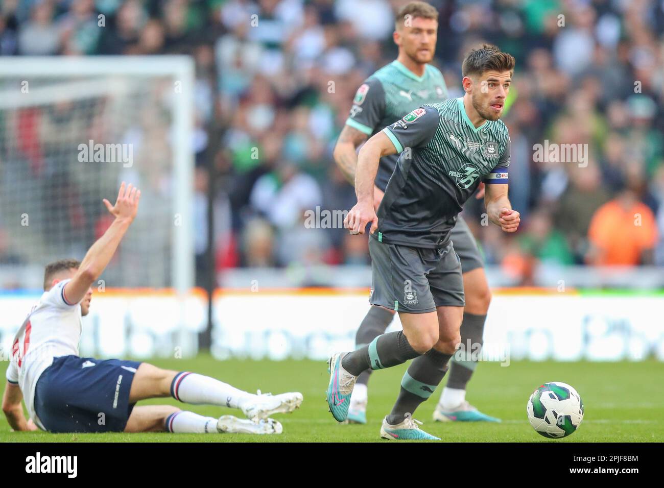 Joe Edwards #8 of Plymouth Argyle gets away from Dion Charles #10 of ...