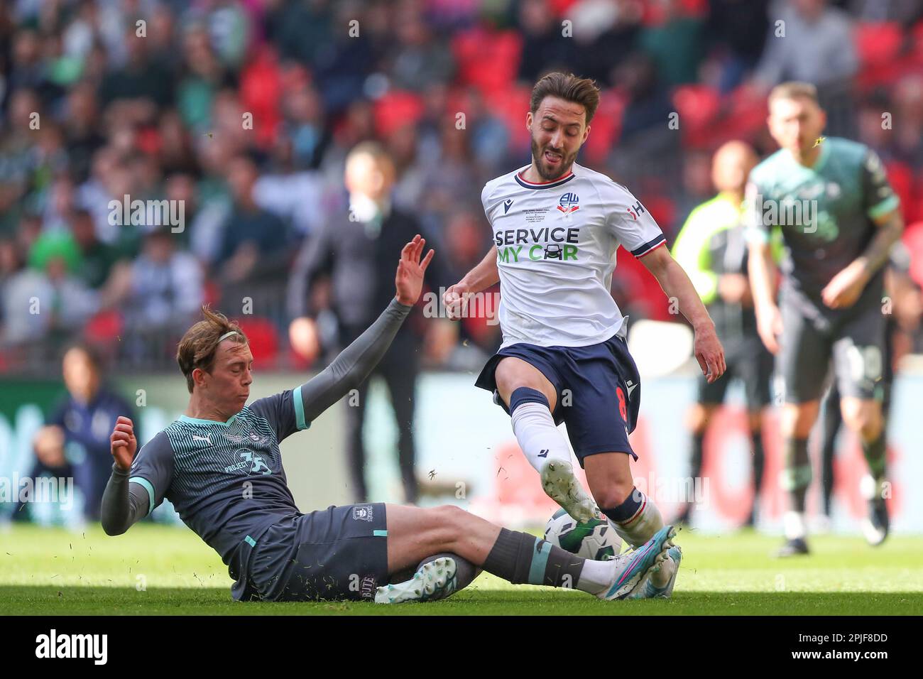 Callum Wright #26 of Plymouth Argyle tackles Josh Sheehan #8 of Bolton ...