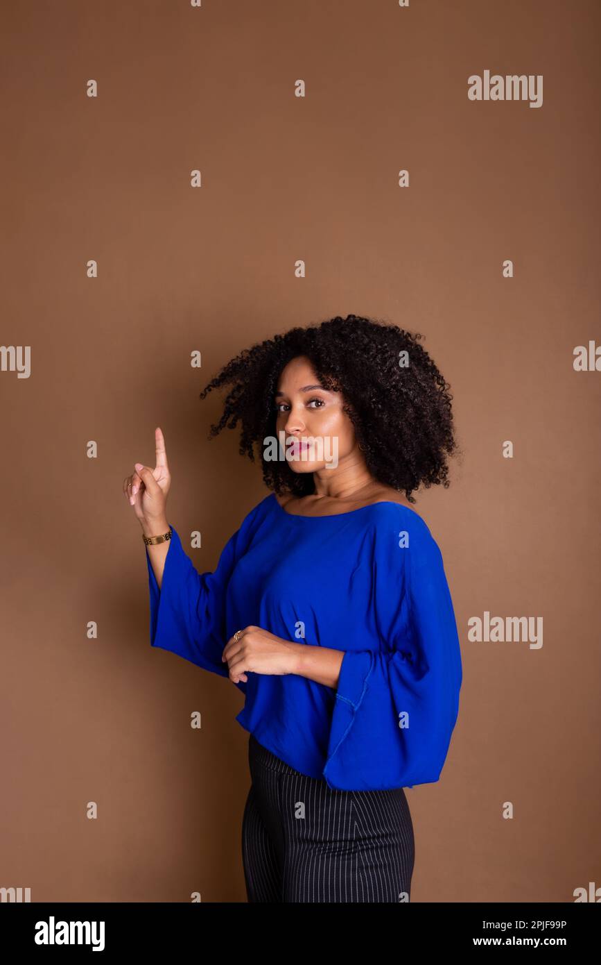 Beautiful young business woman making hand gestures. Standing against a ...