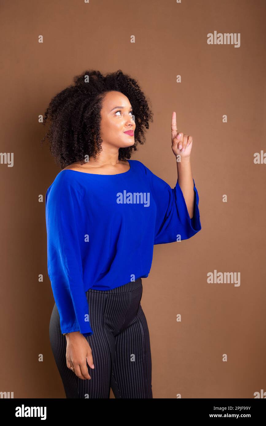 Beautiful young business woman making hand gestures. Standing against a ...