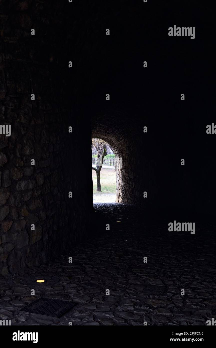 Dark and covered passage in the boundary wall of a castle Stock Photo ...