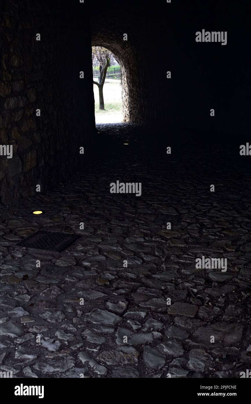 Dark and covered passage in the boundary wall of a castle Stock Photo ...
