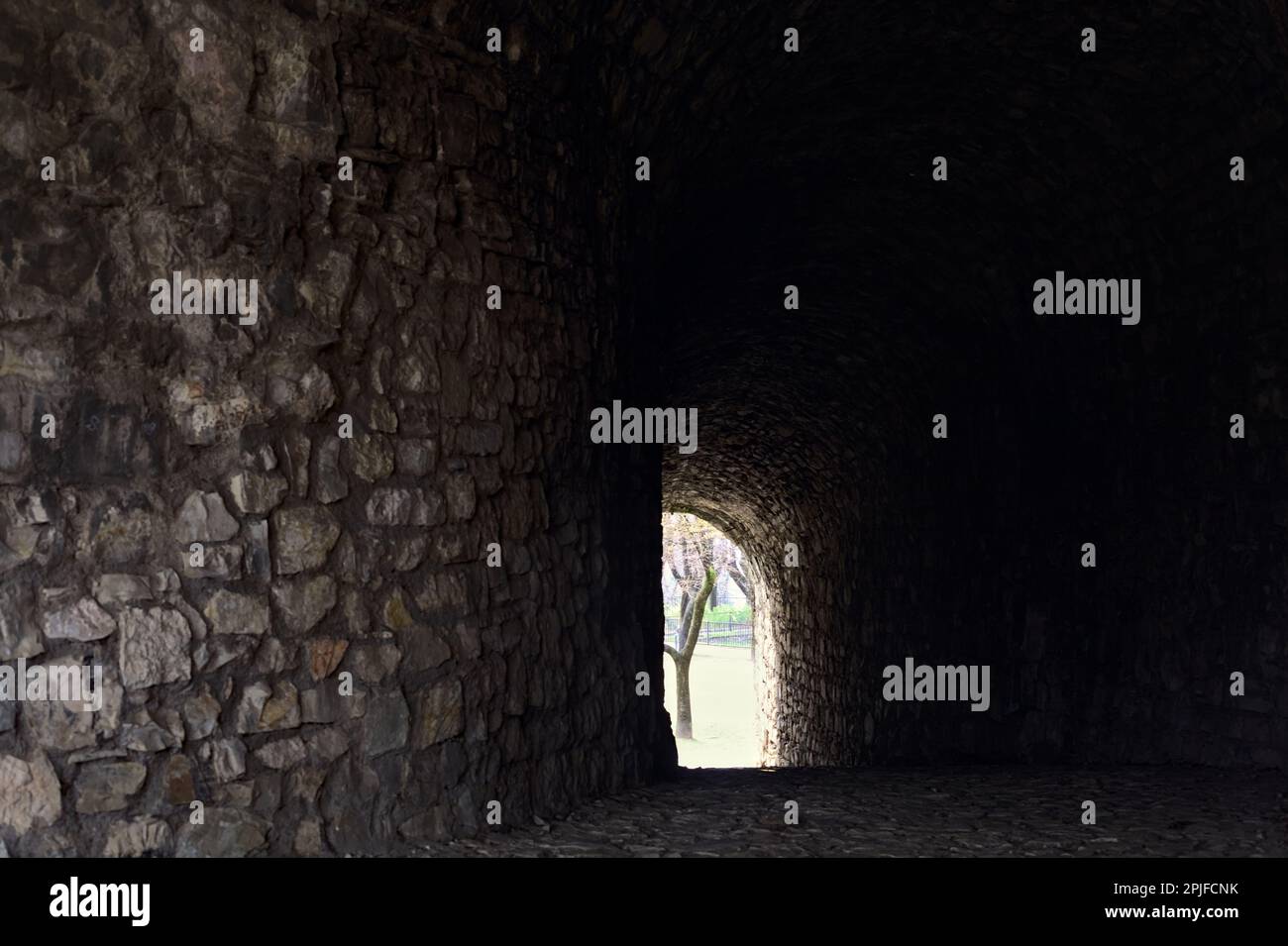 Dark and covered passage in the boundary wall of a castle Stock Photo ...