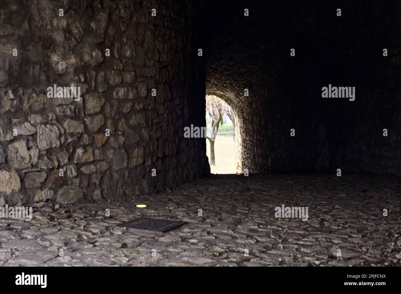Dark and covered passage in the boundary wall of a castle Stock Photo ...