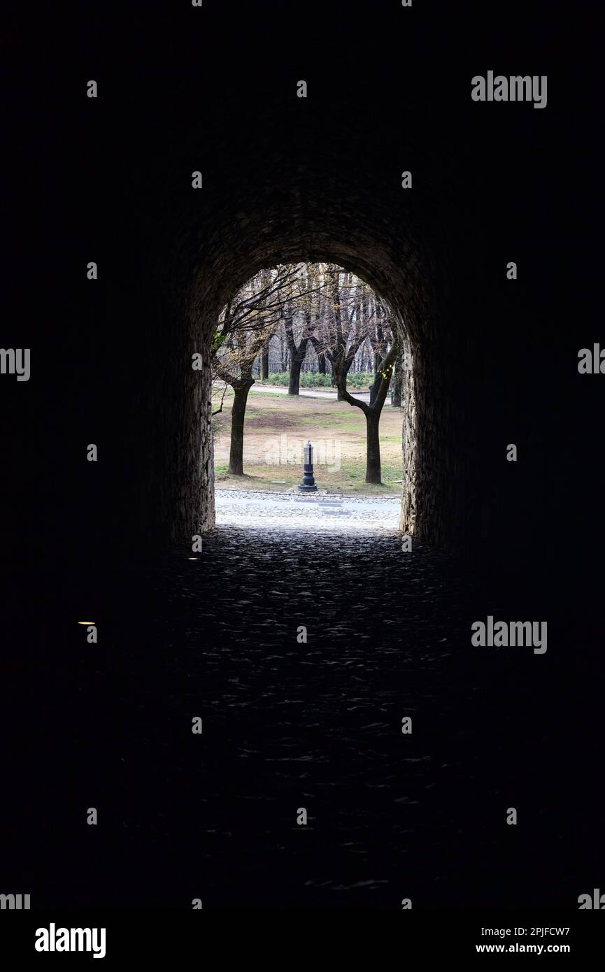 Dark and covered passage in the boundary wall of a castle Stock Photo ...
