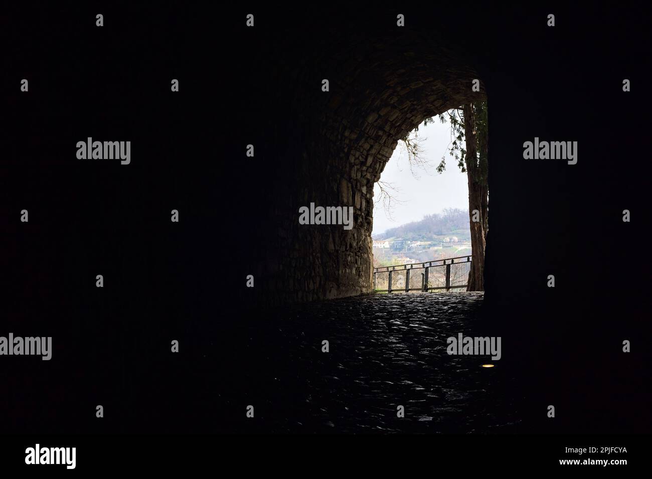 Dark and covered passage in the boundary wall of a castle Stock Photo ...