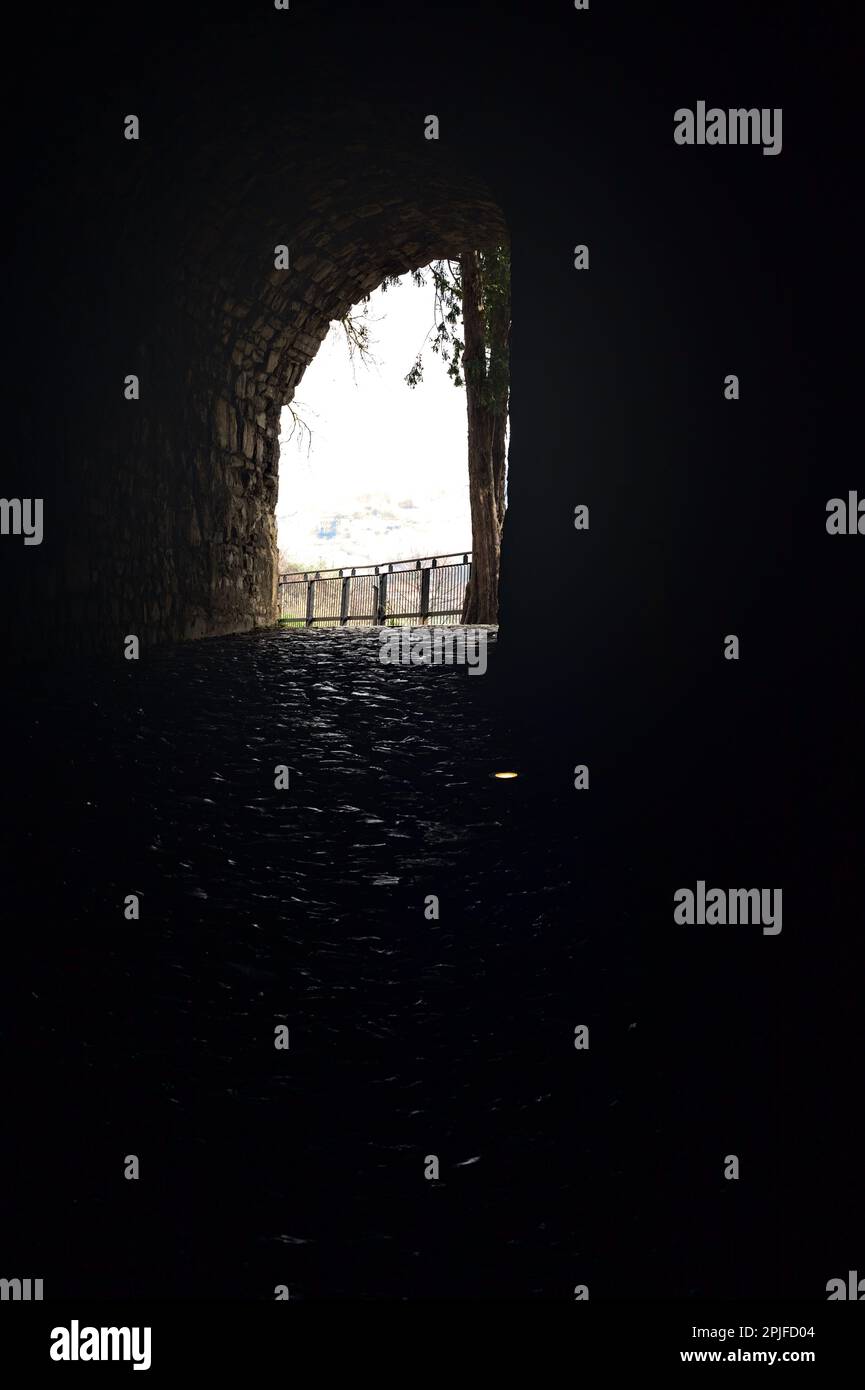 Dark and covered passage in the boundary wall of a castle Stock Photo ...