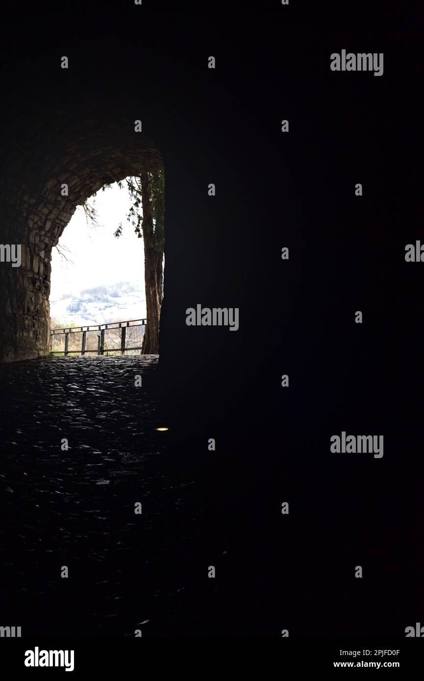 Dark and covered passage in the boundary wall of a castle Stock Photo ...