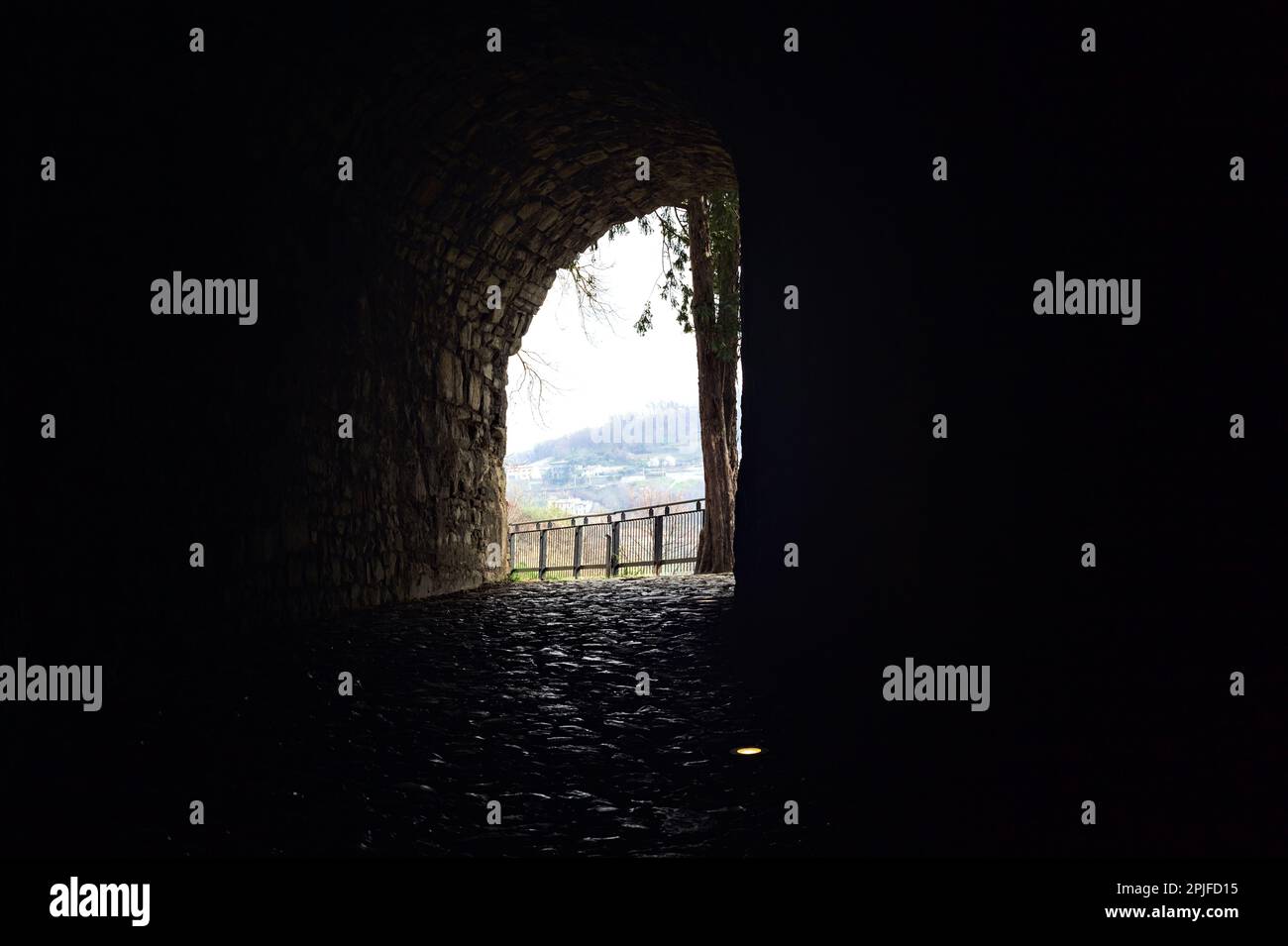 Dark and covered passage in the boundary wall of a castle Stock Photo ...