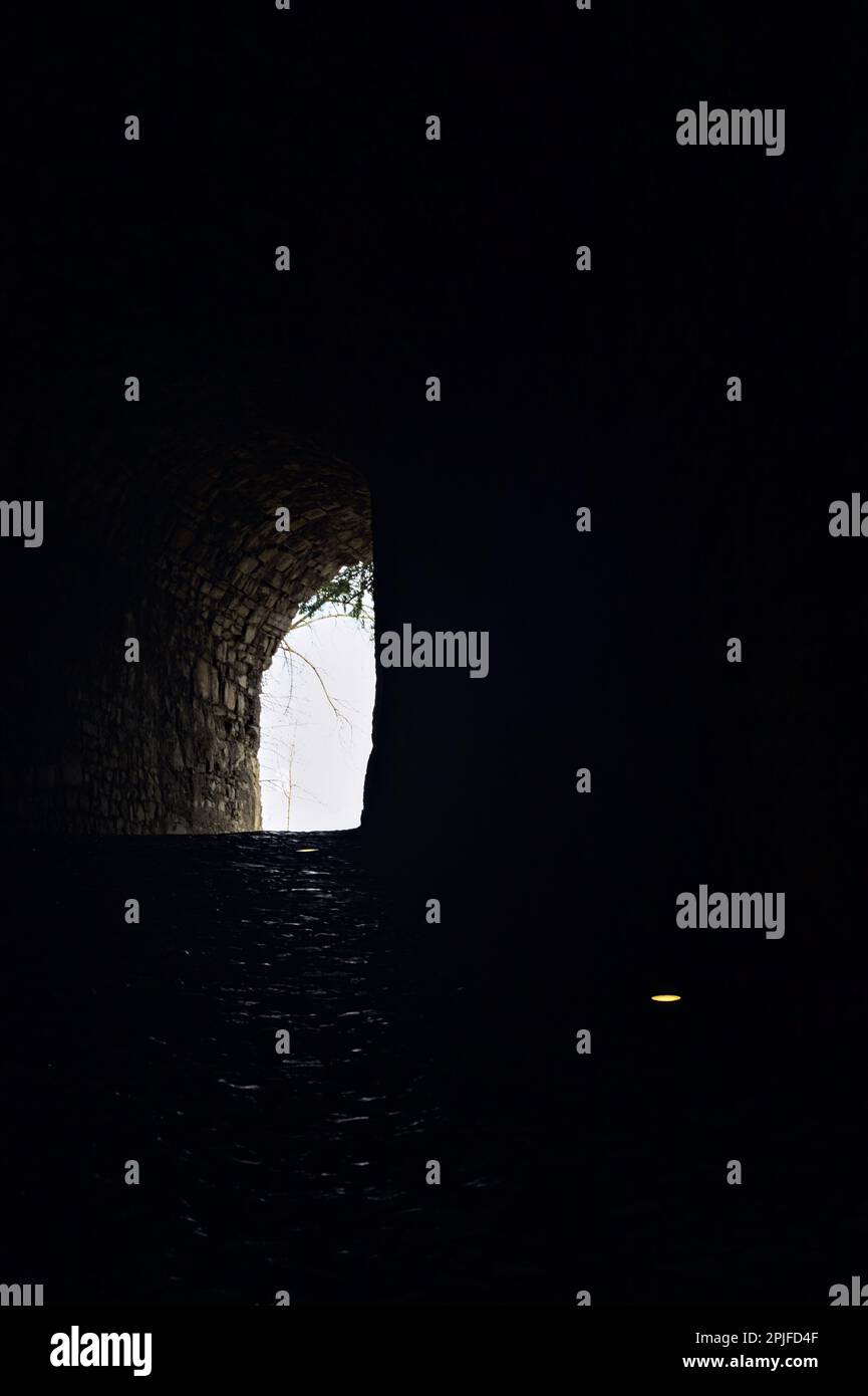 Dark and covered passage in the boundary wall of a castle Stock Photo ...