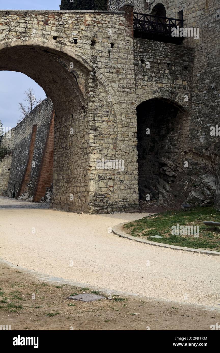 Stone bridge and the gate of a castle seen from the distance on a ...