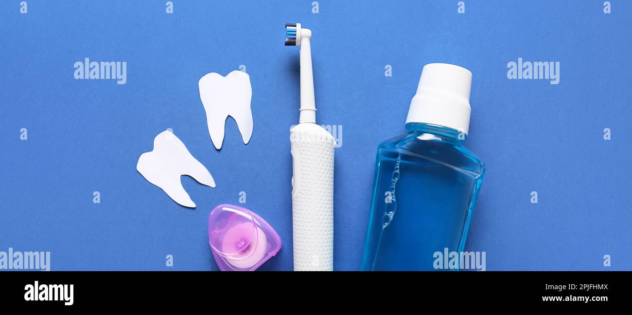 Set for oral hygiene and paper teeth on blue background Stock Photo - Alamy