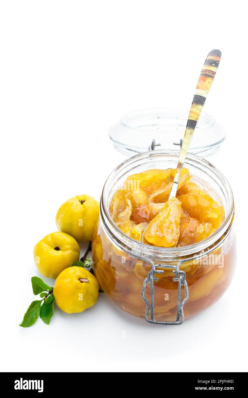 Homemade quince jam in glass jars and fresh quince with leaves isolated ...