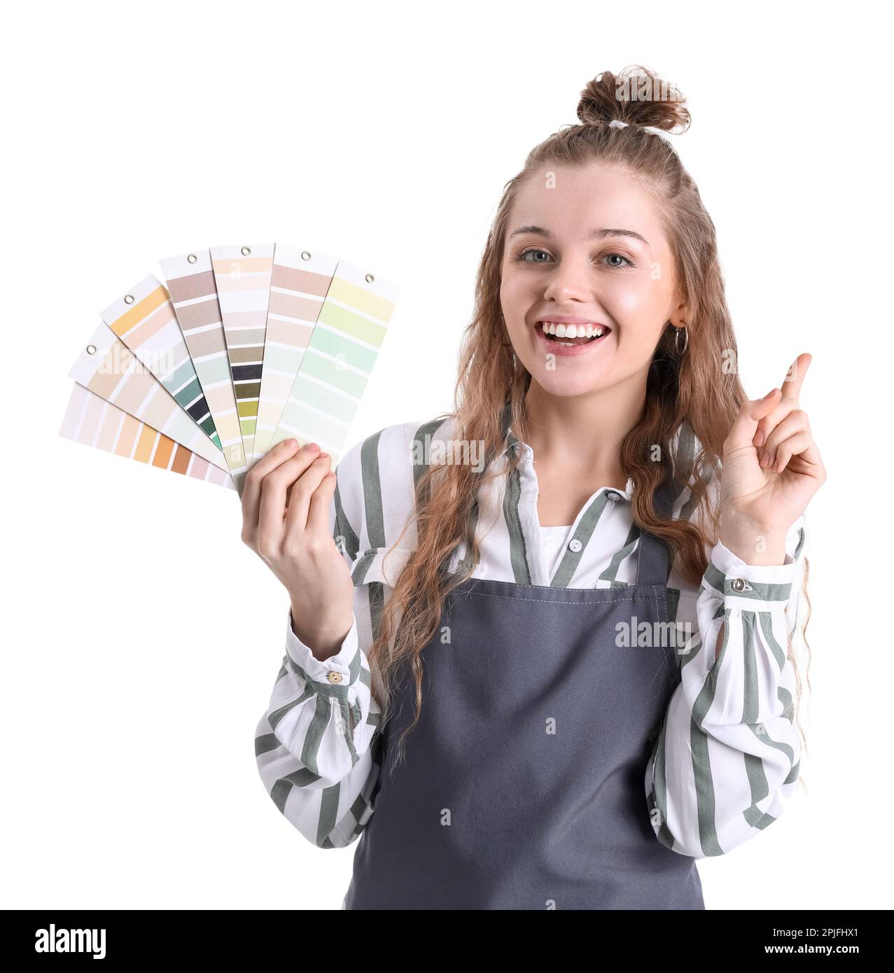 Female artist with paint color palettes pointing at something on white ...