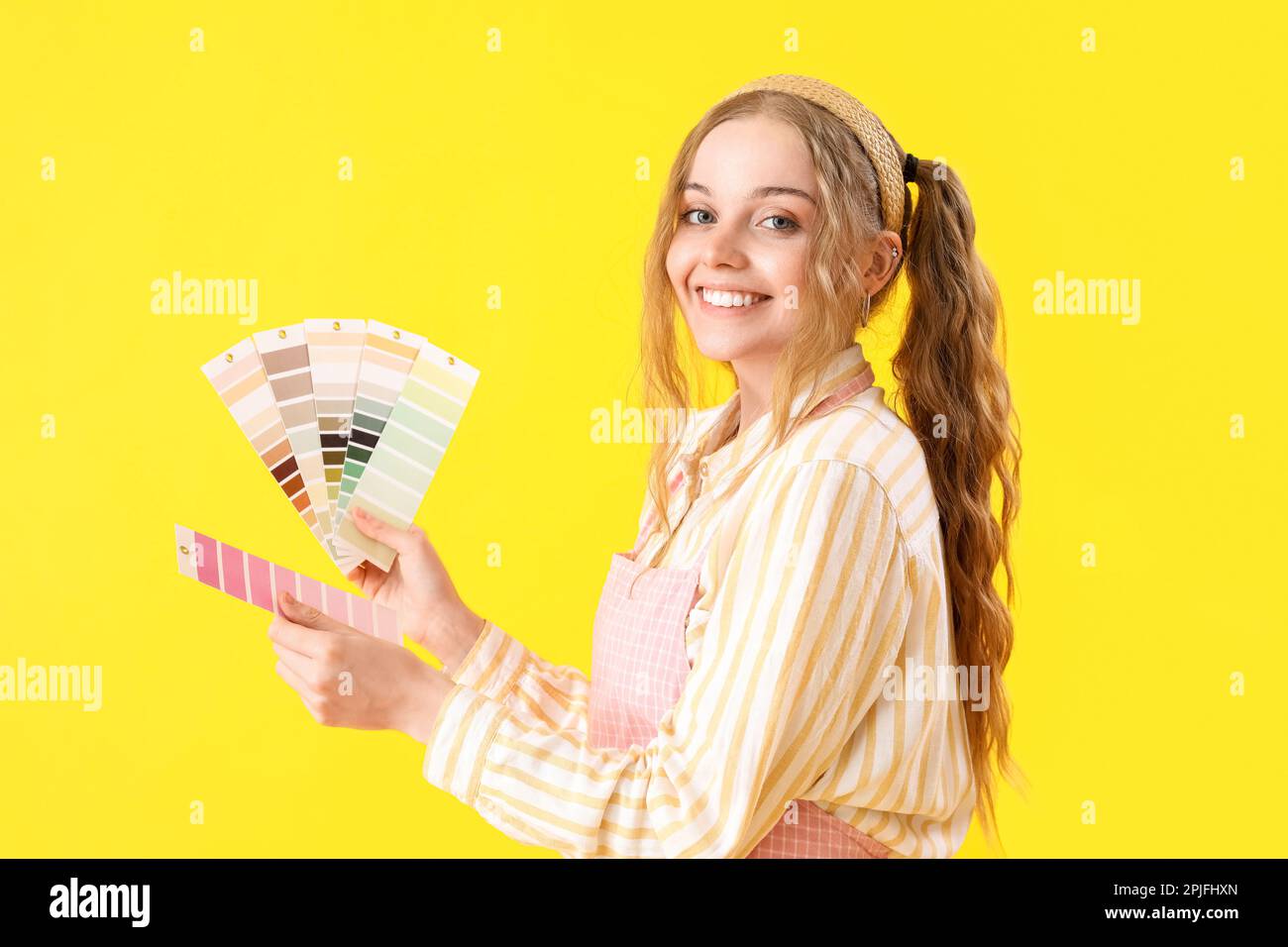 Female artist with paint color palettes on yellow background Stock ...