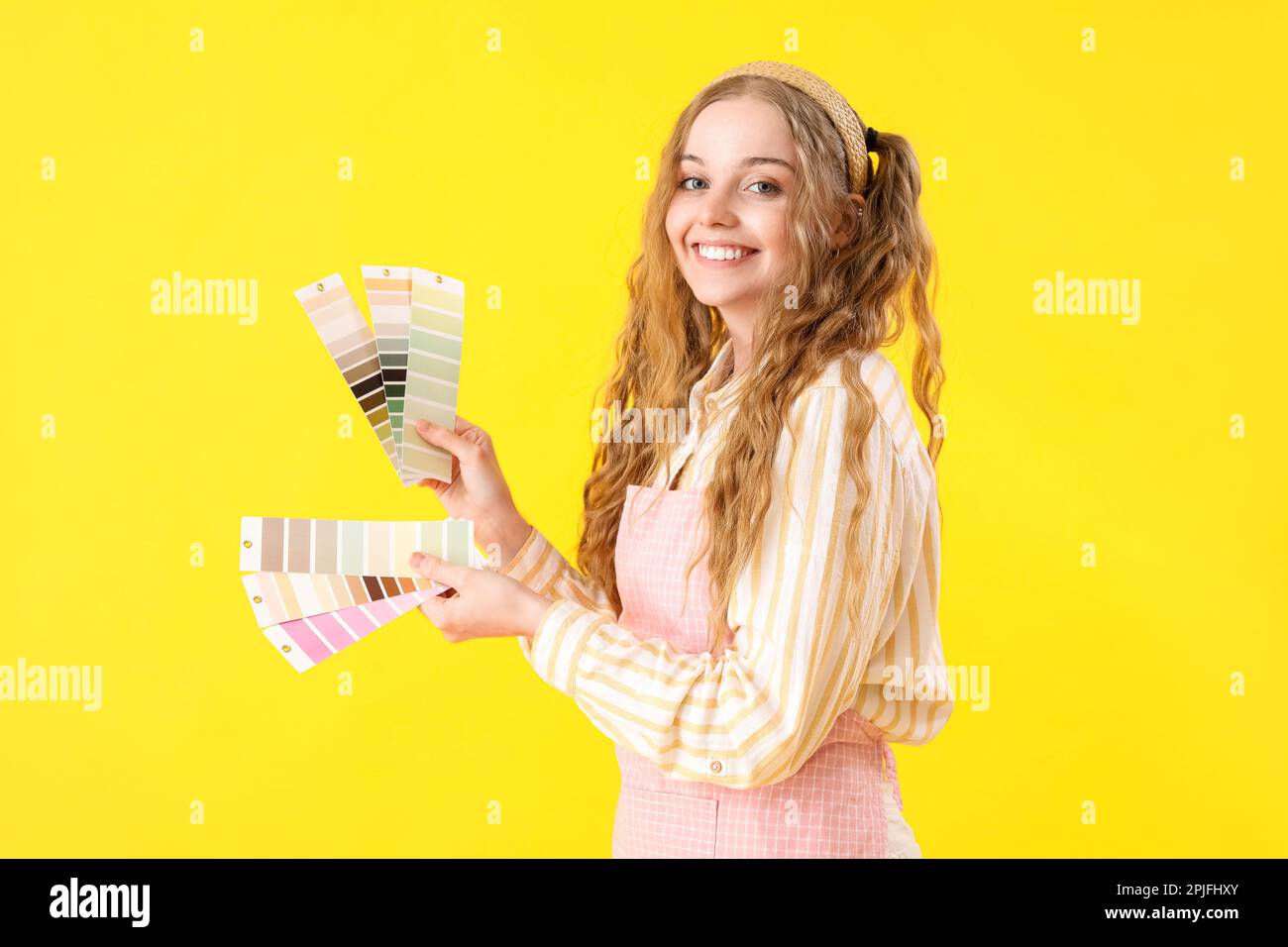 Female artist with paint color palettes on yellow background Stock ...