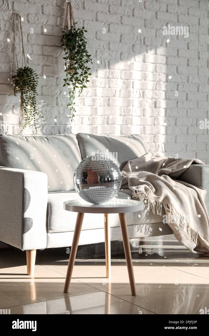 Interior of living room with disco ball and sofa Stock Photo - Alamy
