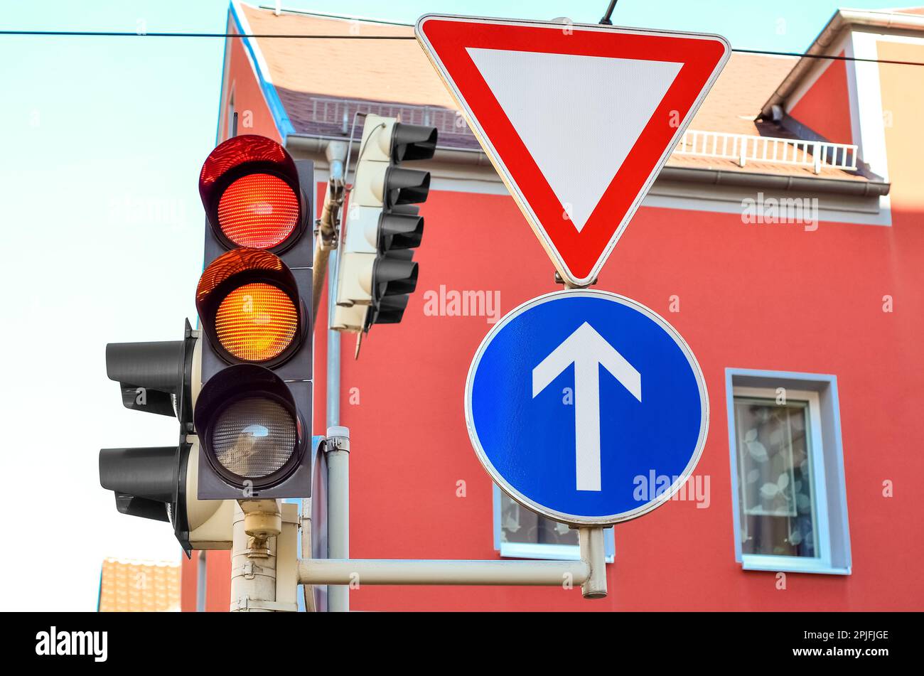 View of traffic lights with road signs in city, closeup Stock Photo - Alamy