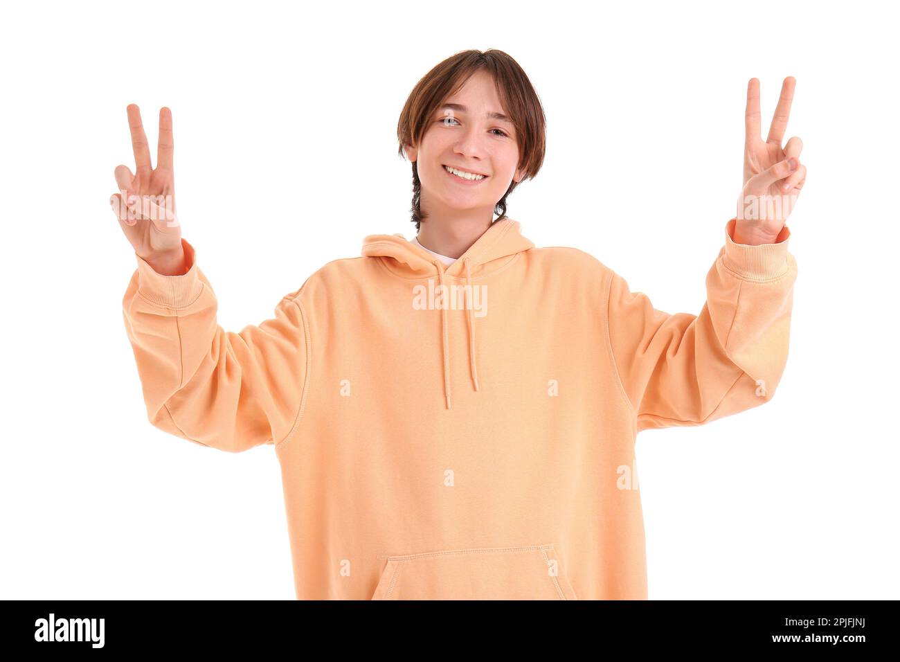 Teenage boy showing victory gesture on white background. Hello concept ...