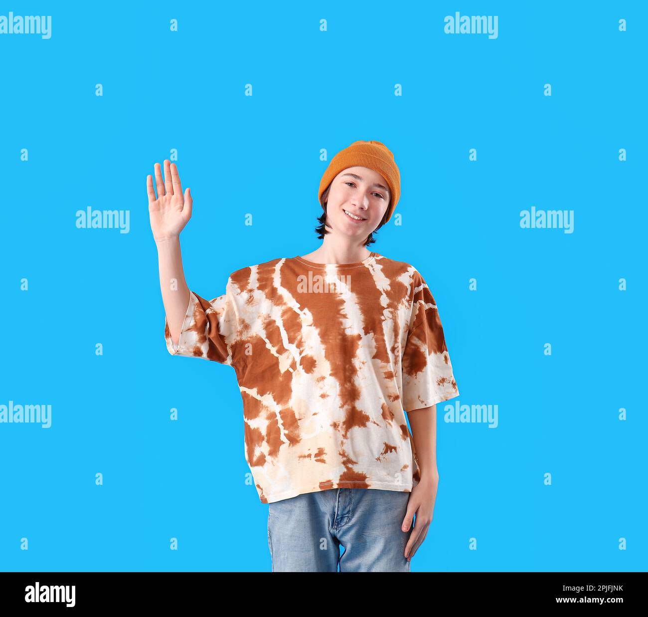 Teenage boy waving hand on blue background. Hello concept Stock Photo ...