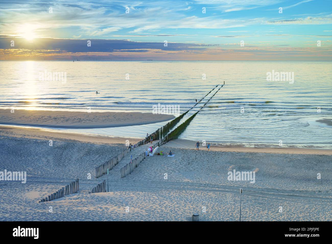 View from the dutch dunes with breakwaters running into the sea from ...