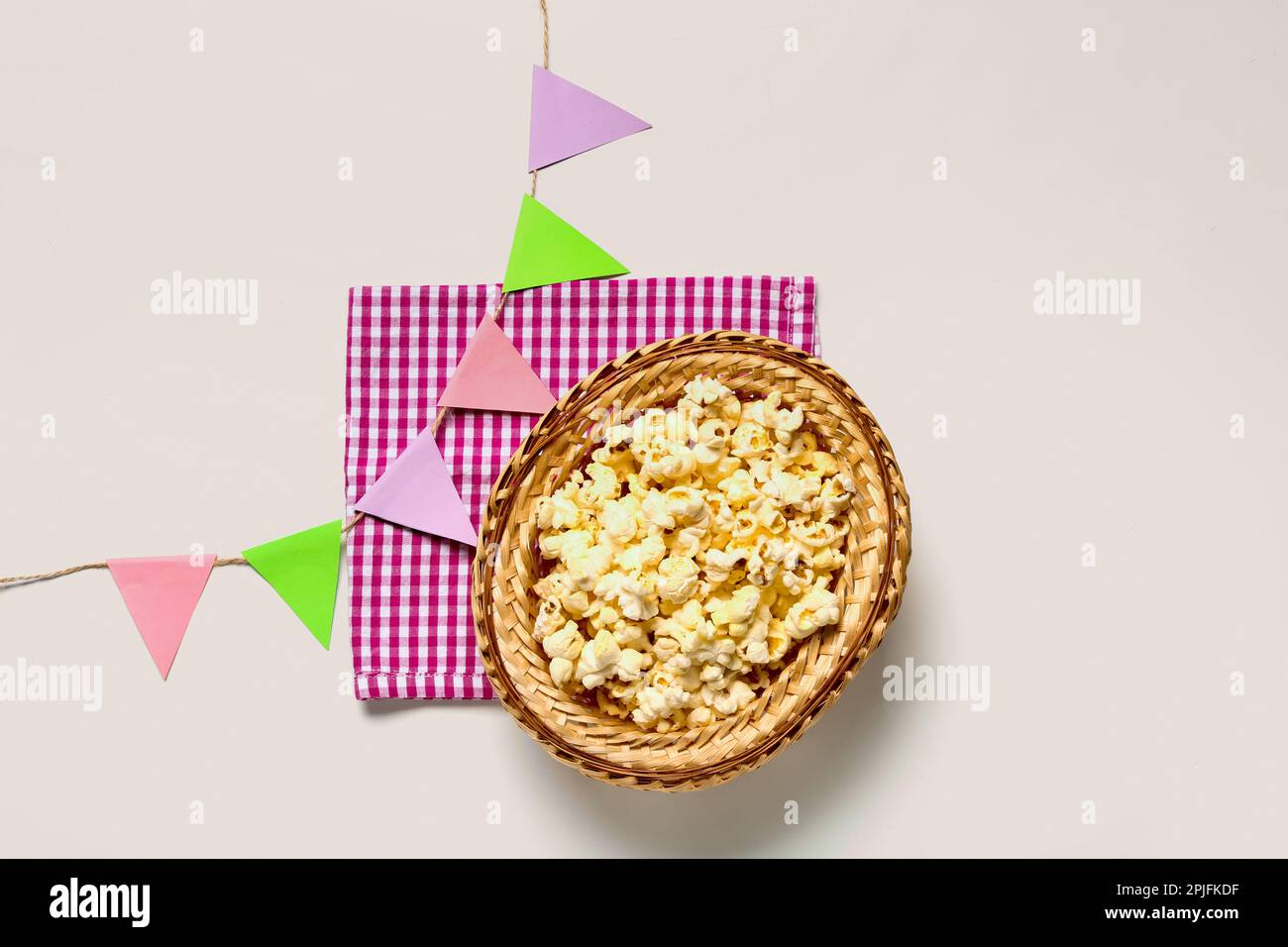 Straw hat with popcorn, flags and napkin on white background. Festa Junina (June Festival ...