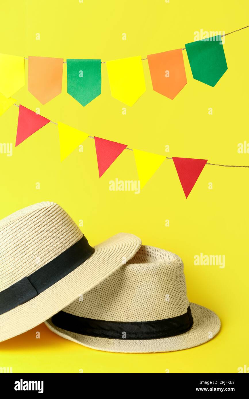 Straw hats with flags on yellow background. Festa Junina (June Festival ...