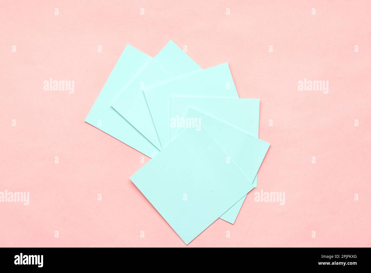 Blue sticky notes on pink background Stock Photo - Alamy