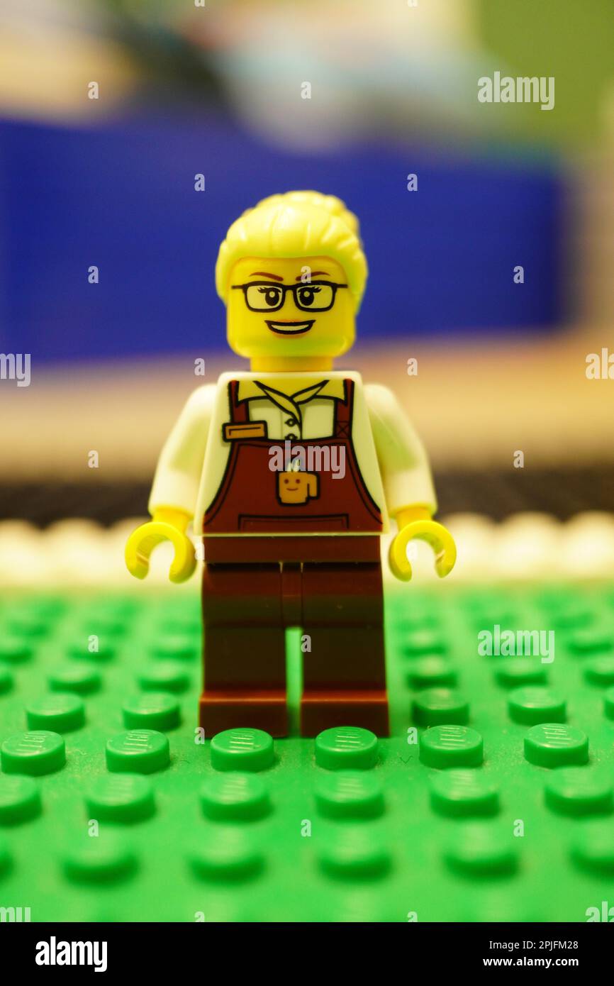 A vertical image of a small Lego figurine dressed in a bright and ...